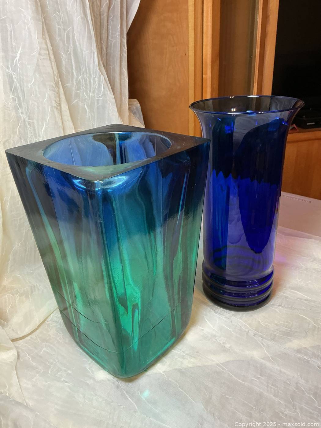 Two tall colored glass vases | Maxsold