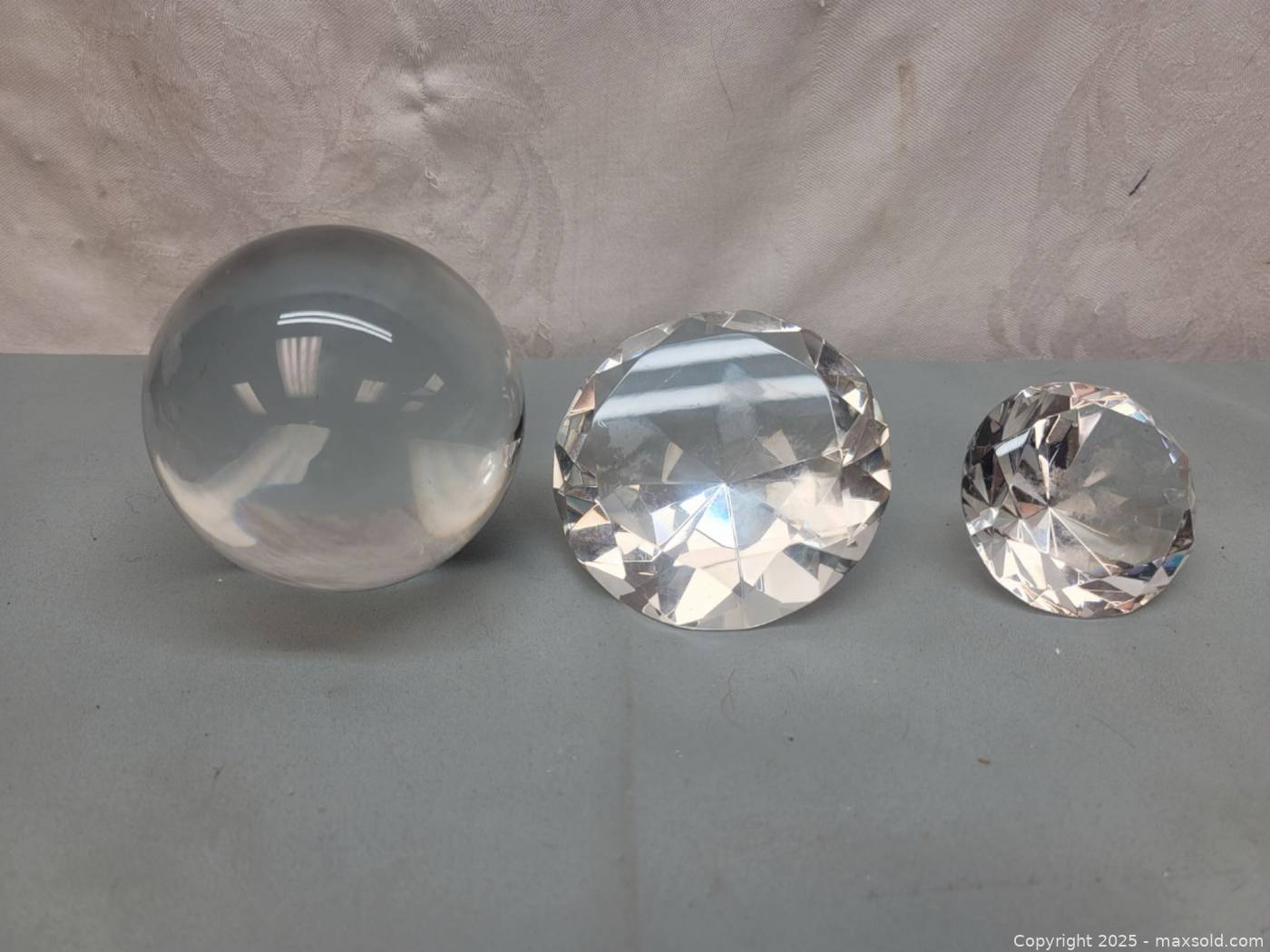 Glass sphere and two faceted diamond paperweights | Maxsold