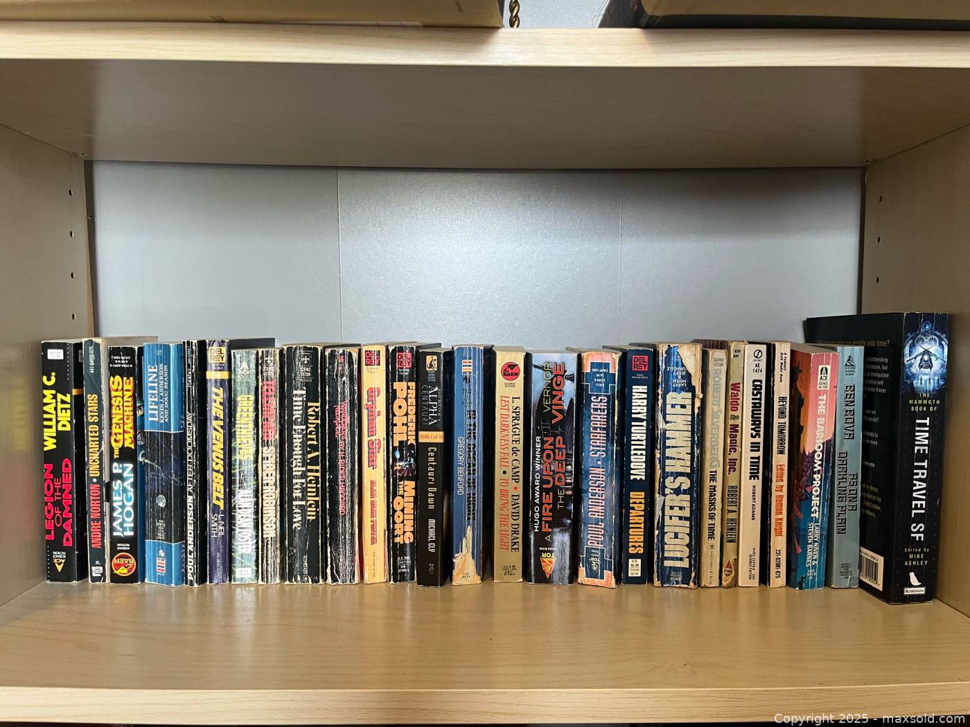 Shelf of paperback science fiction and fantasy novels | Maxsold