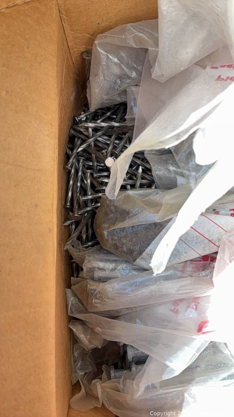 Assorted wood screws and nails in two boxes | Maxsold