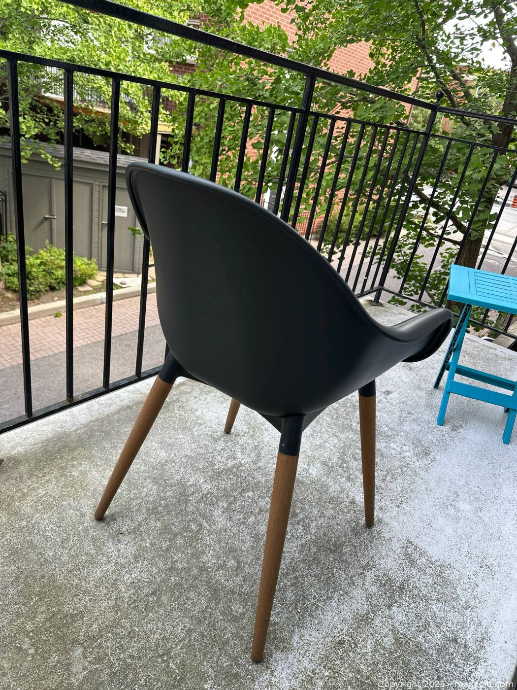 Outdoor black chair and blue plastic side table | Maxsold