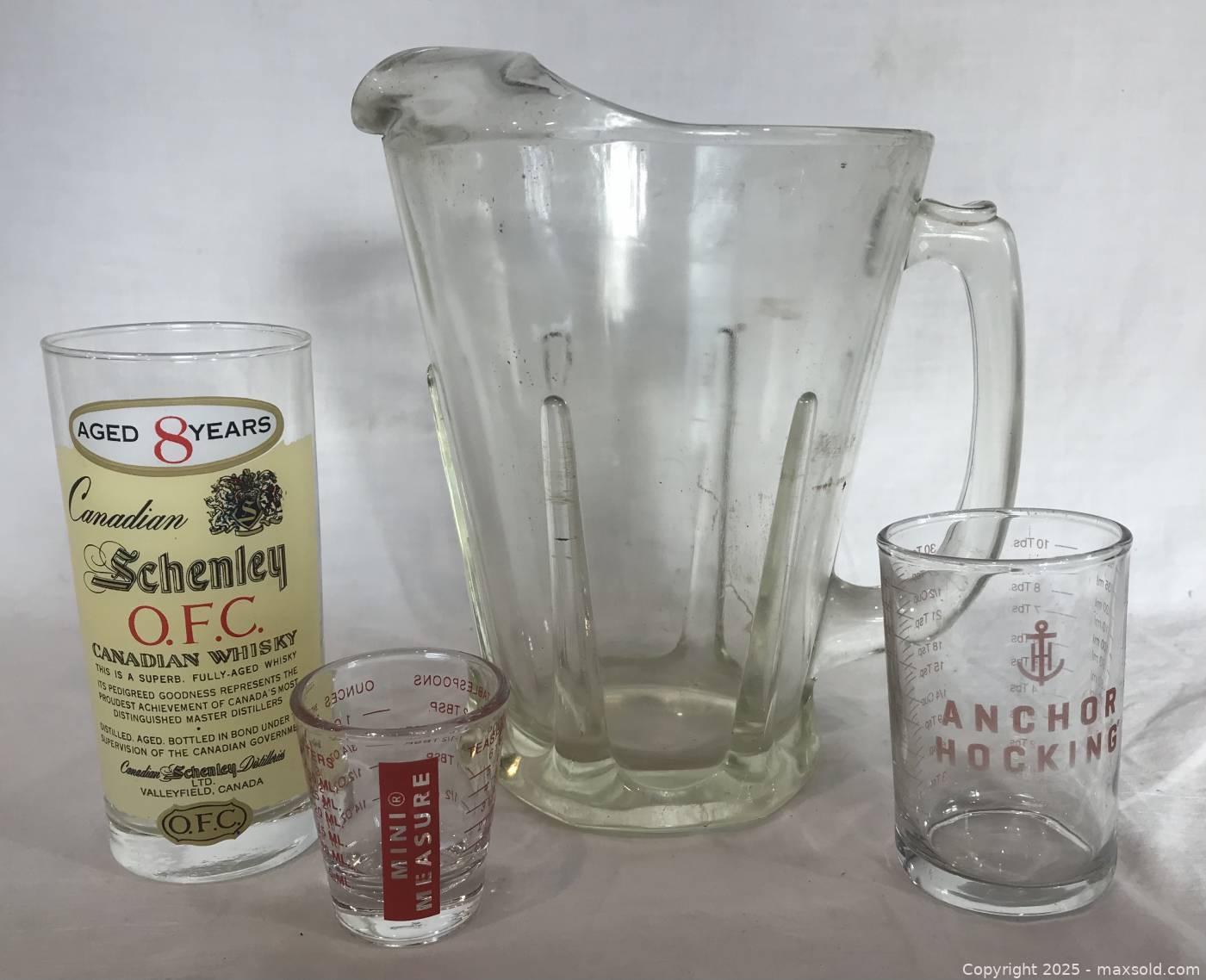 Depression era glass pitcher with three assorted glasses | Maxsold