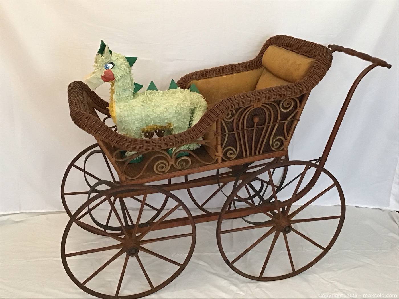 Antique woven rattan pram on wood and metal frame | Maxsold