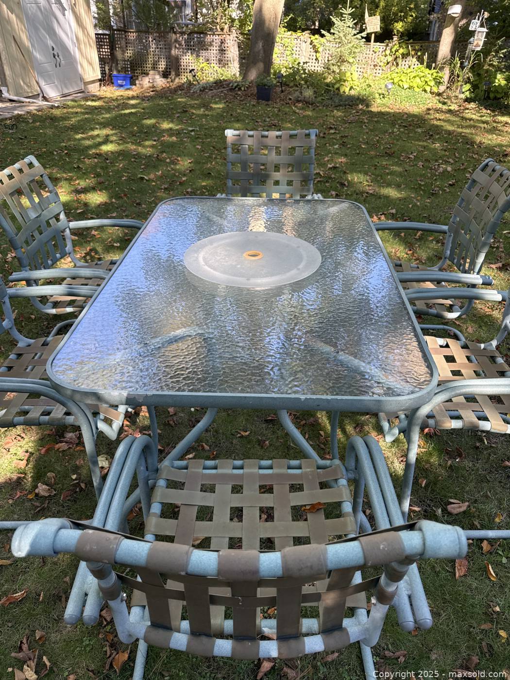 Outdoor patio dining set glass table and 6 strap dining chairs | Maxsold