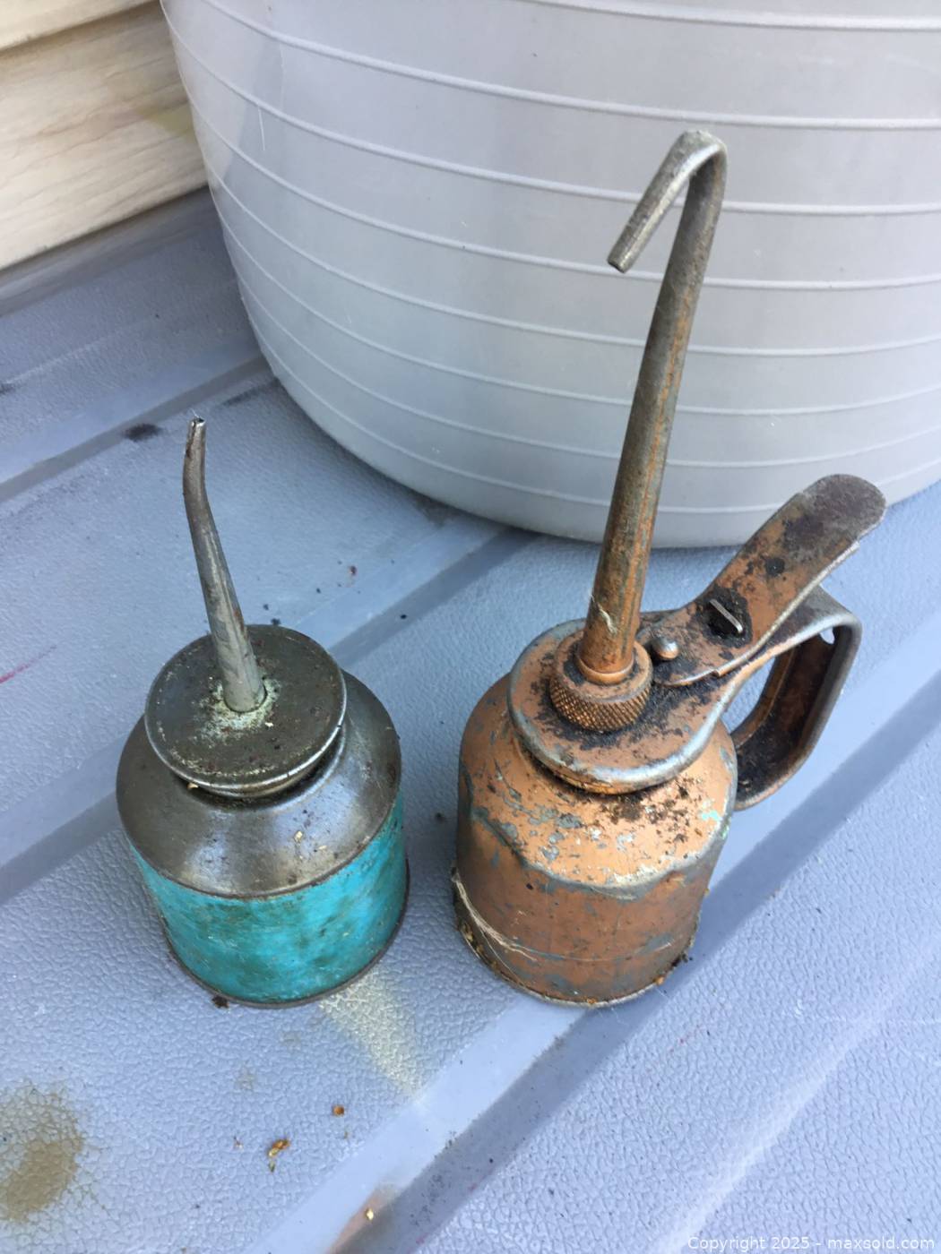 Pair of vintage metal oil cans | Maxsold