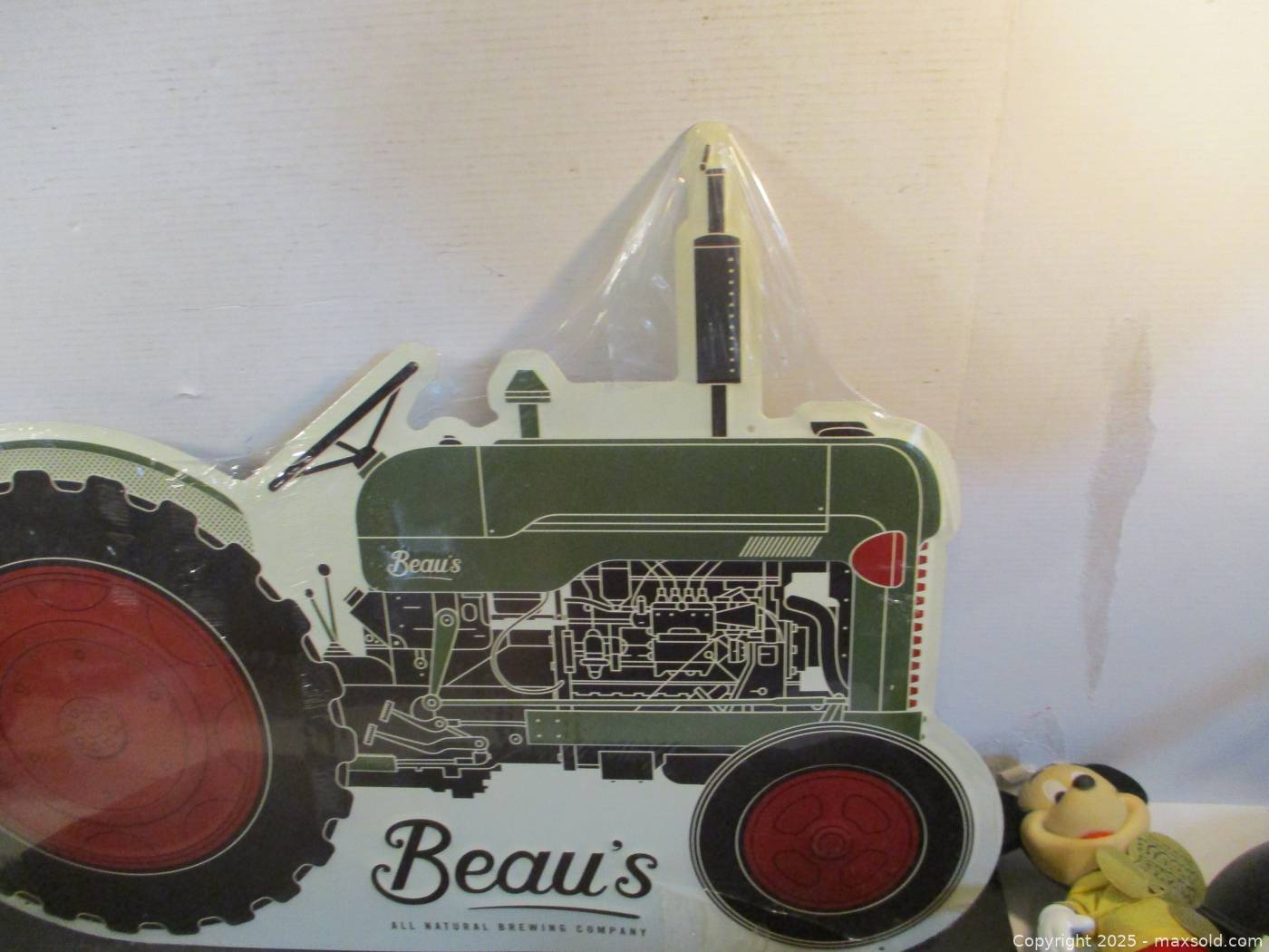 Beau's tractor-shaped metal brewery sign | Maxsold