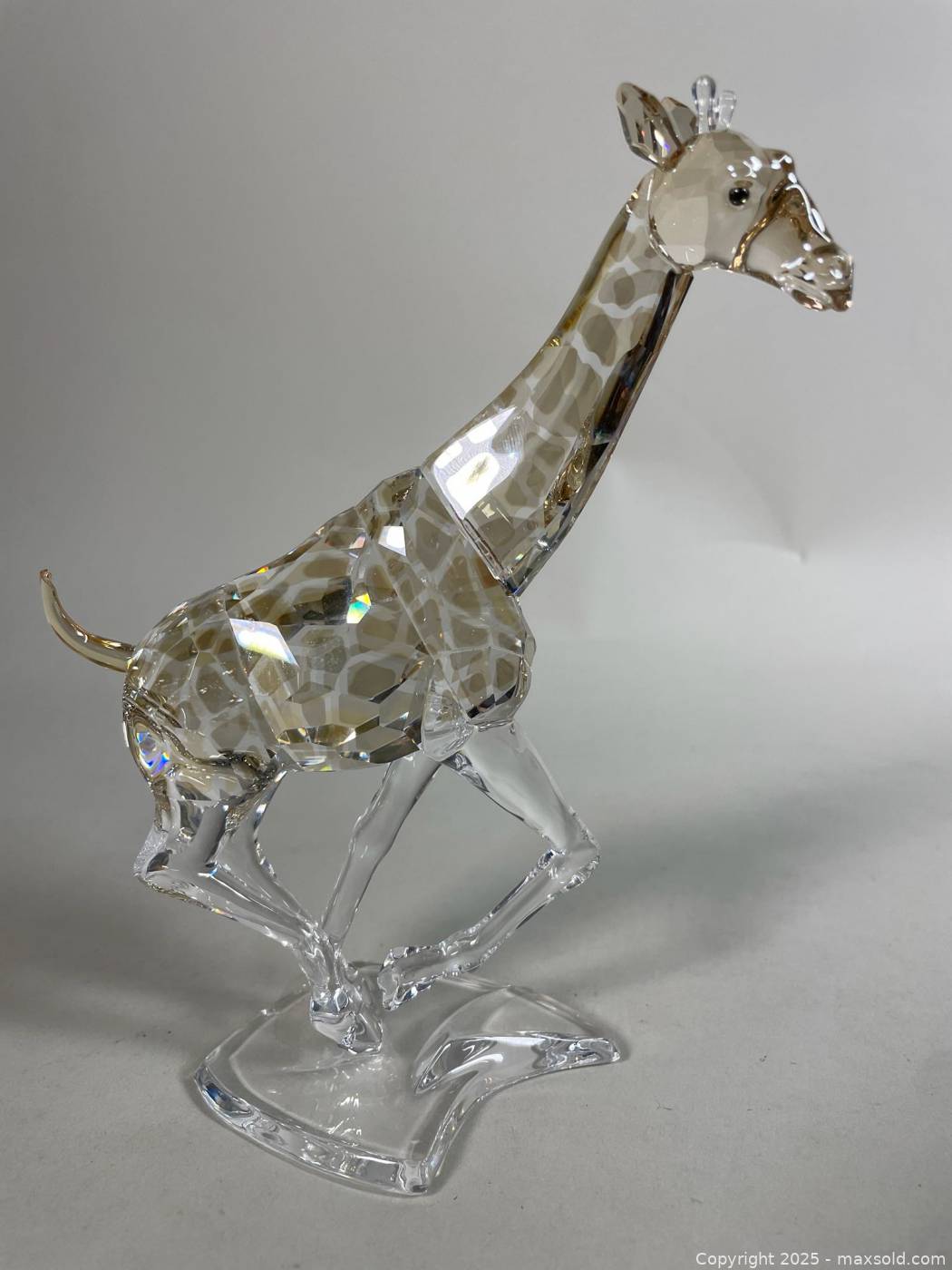 Swarovski crystal giraffe and dragon figurines | Maxsold
