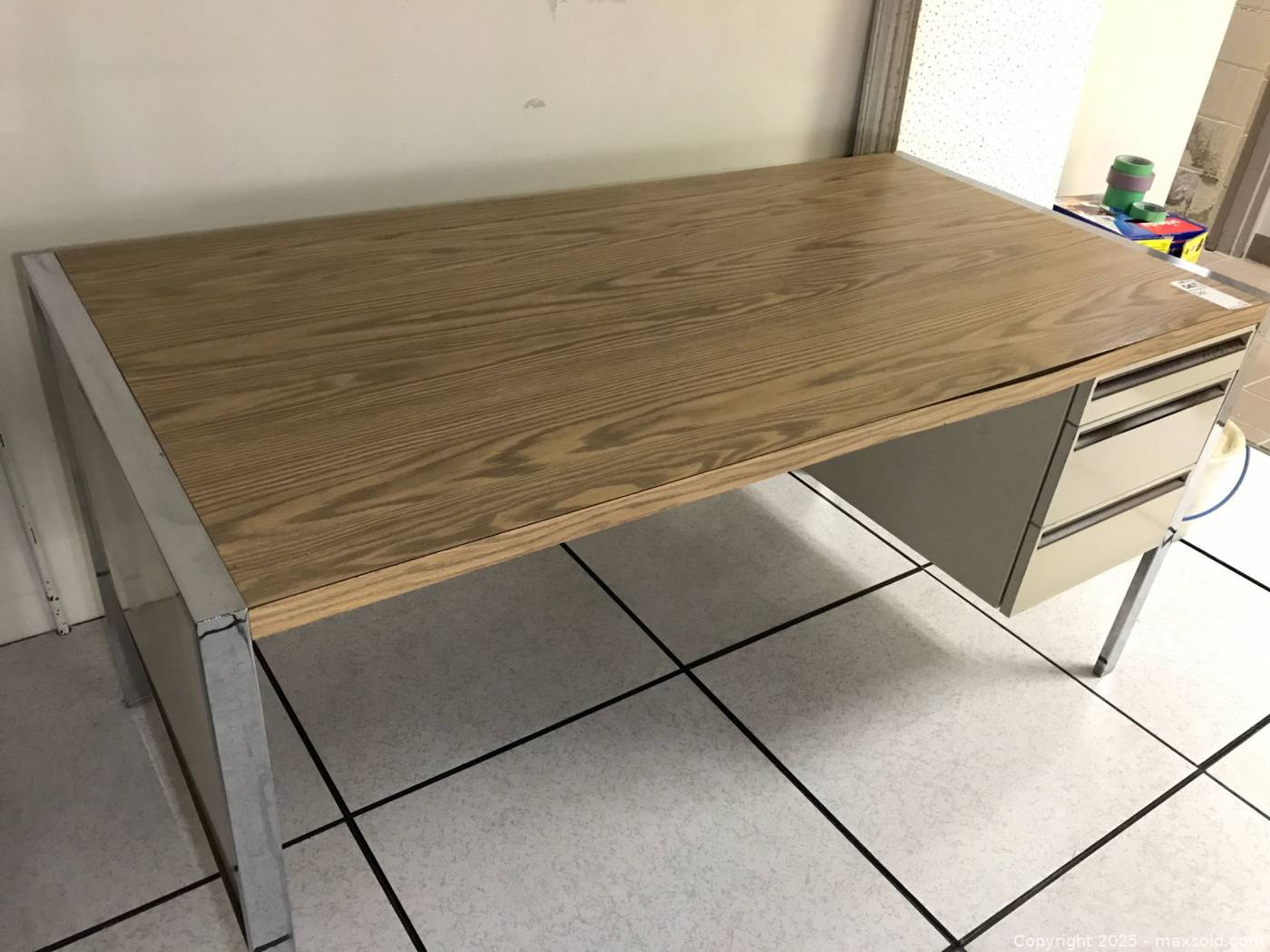 Metal desk with wood grain laminate top | Maxsold