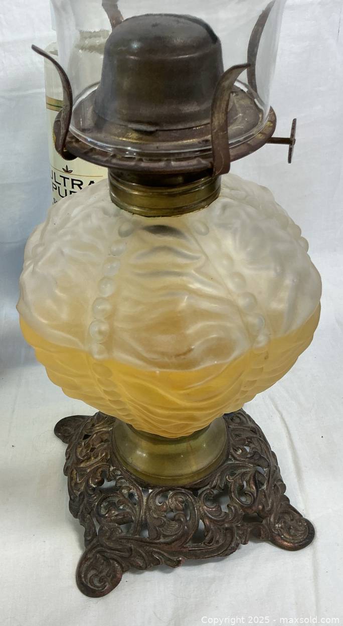 Three vintage oil lamps, carved plaque with sealed purple glass globe ...