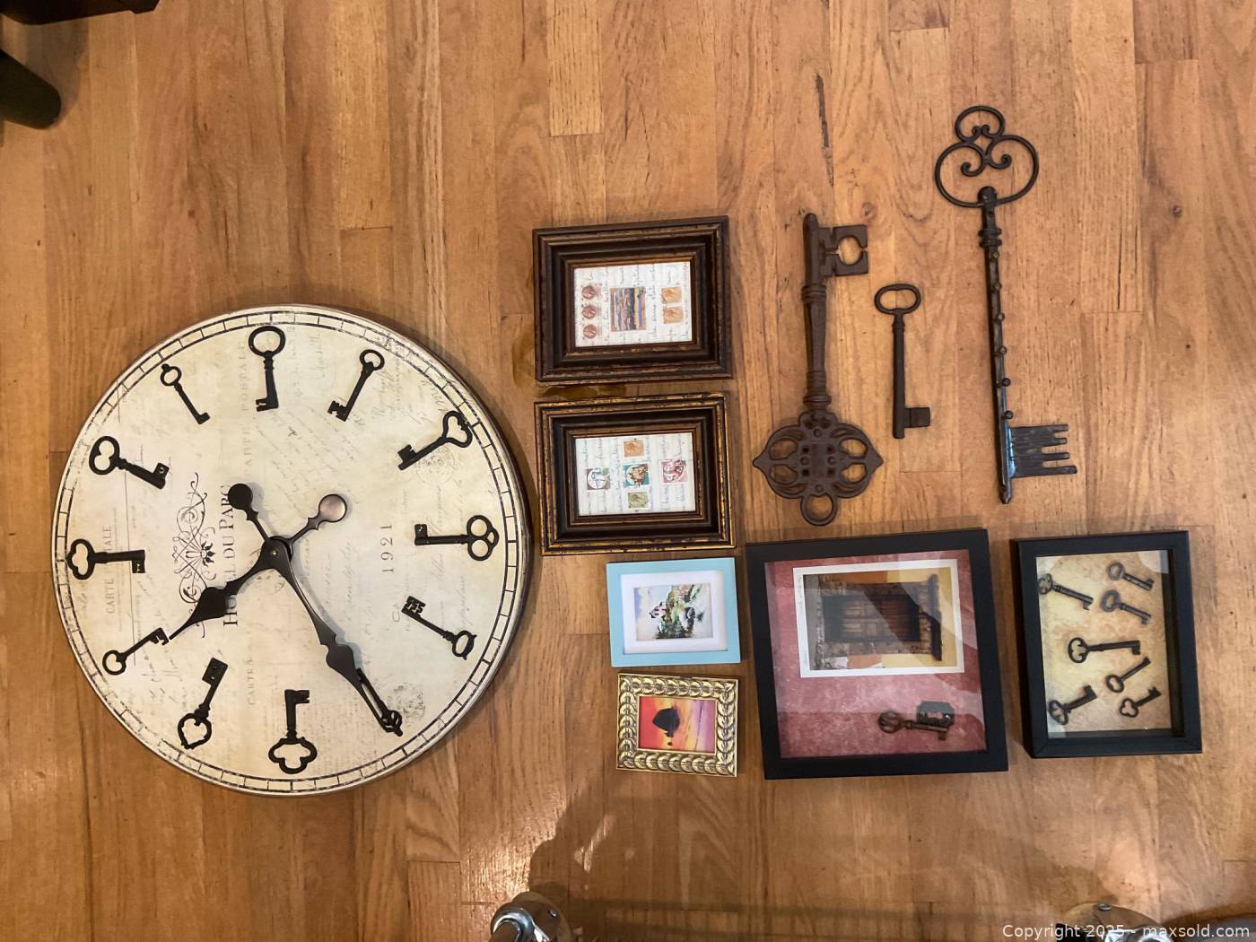 Clock, decorative keys and framed wall art | Maxsold