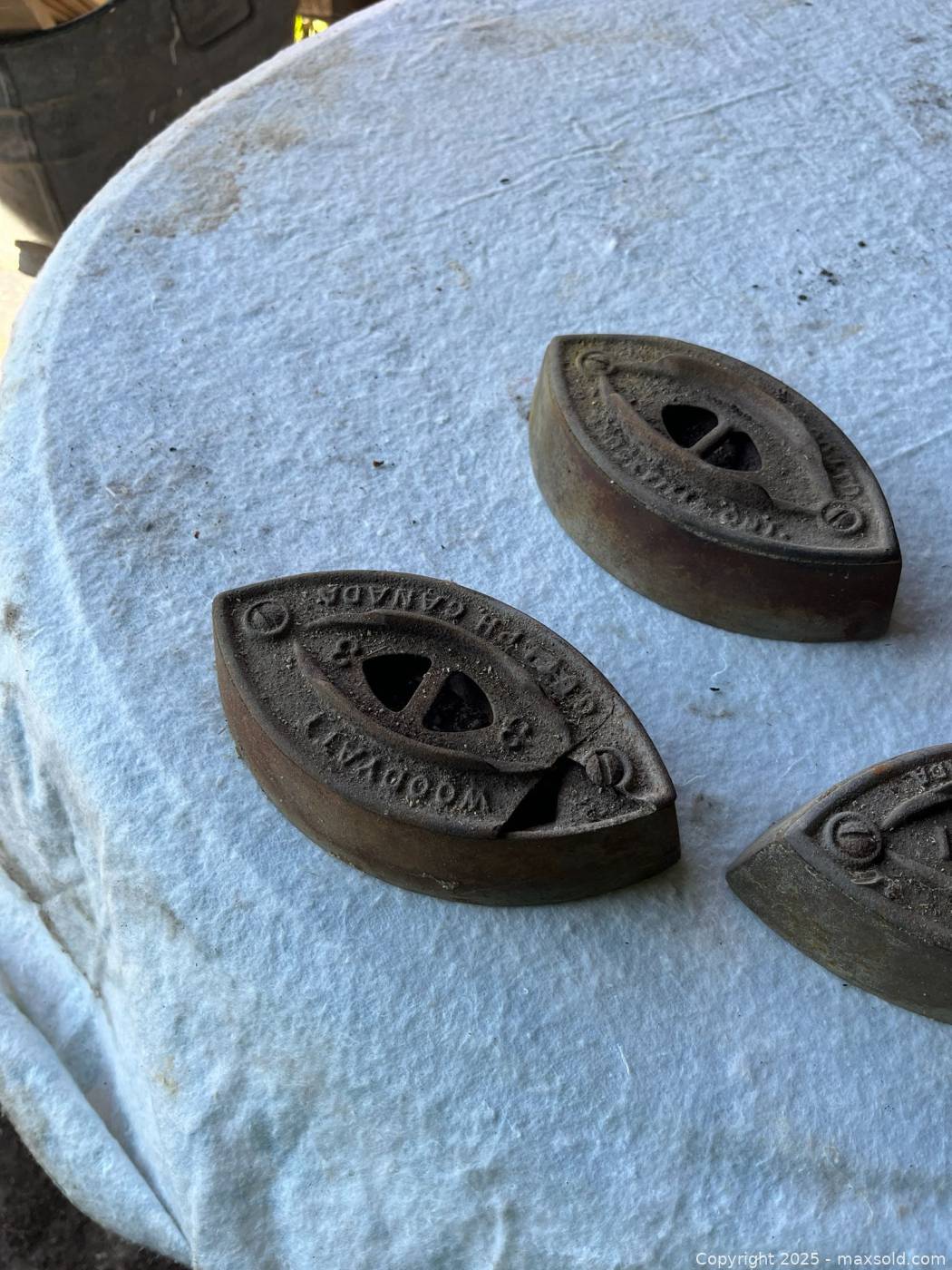 Antique cast iron sad iron bases and pot | Maxsold