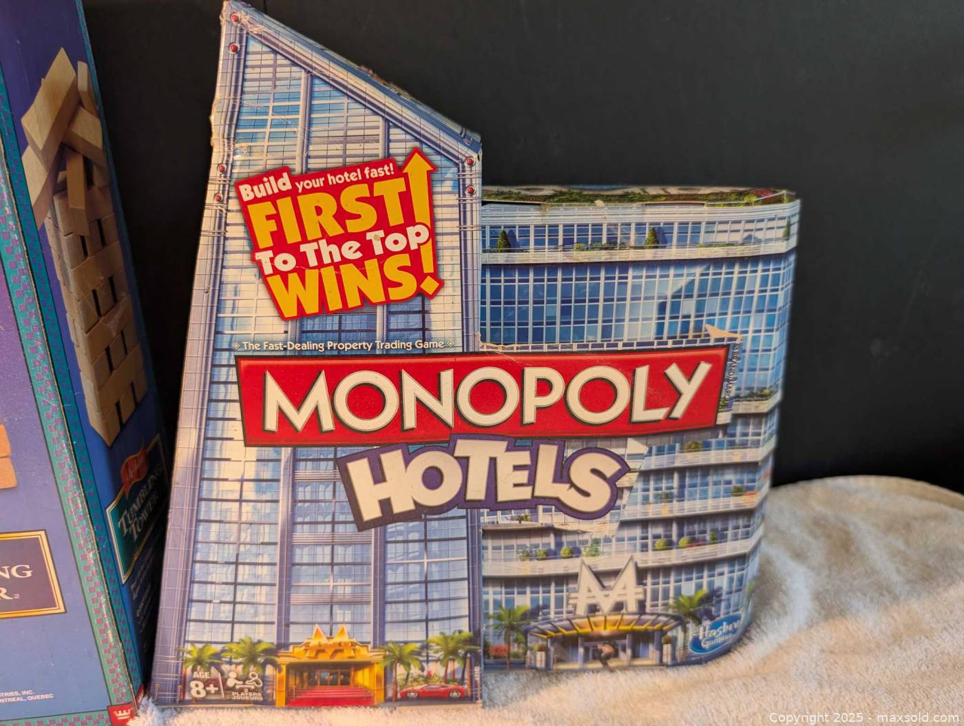 Monopoly Hotels board game and Tumbling Tower stacking blocks | Maxsold