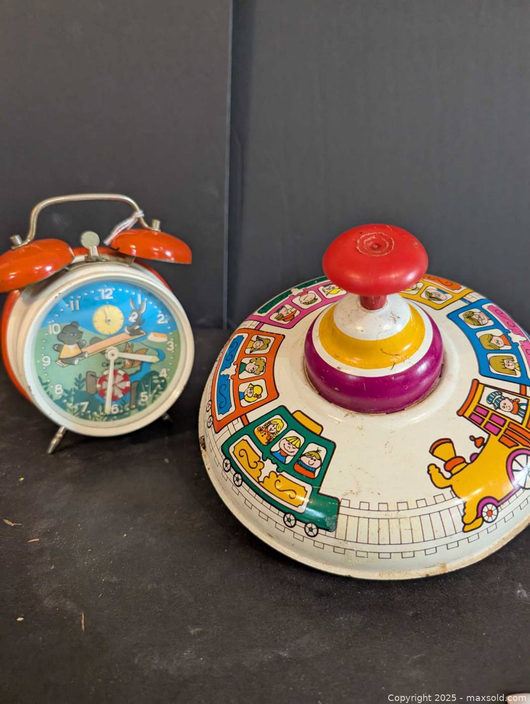 Metal spinning top and cartoon alarm clock | Maxsold
