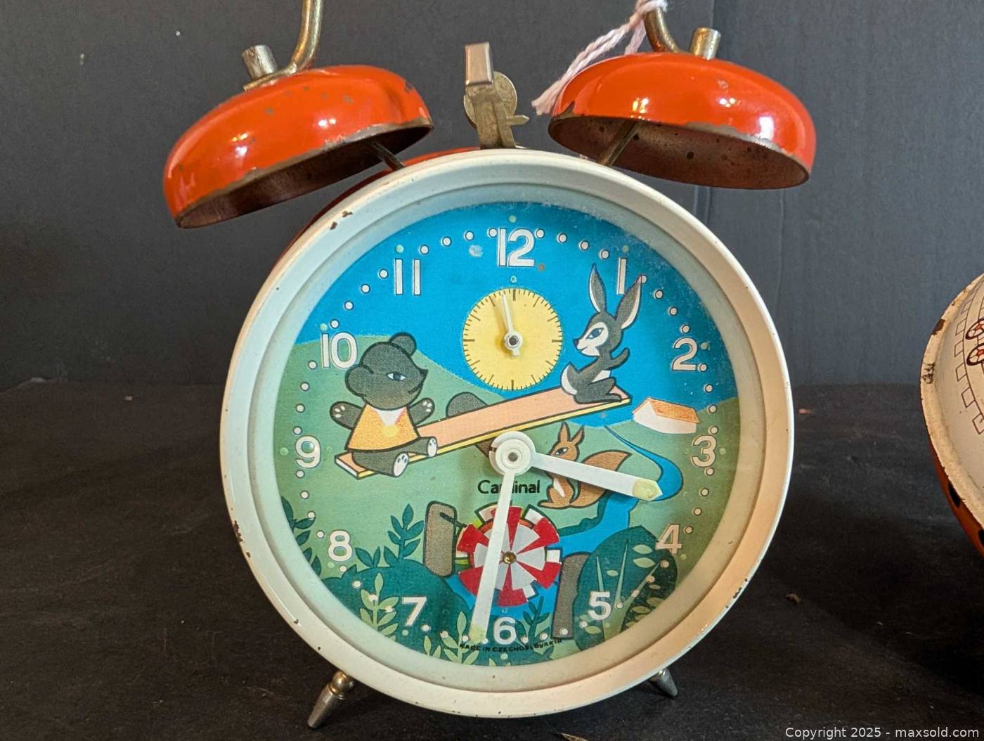 Metal spinning top and cartoon alarm clock | Maxsold