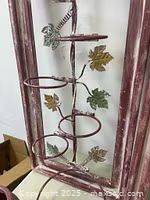 Pair of arched metal window-style plant holders | Maxsold