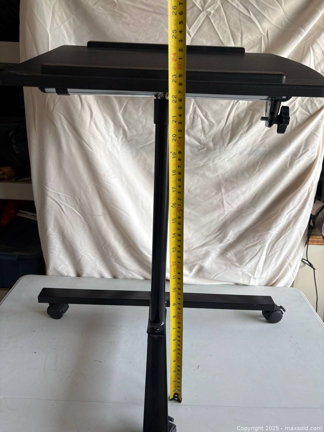 Black adjustable height rolling desk | Maxsold