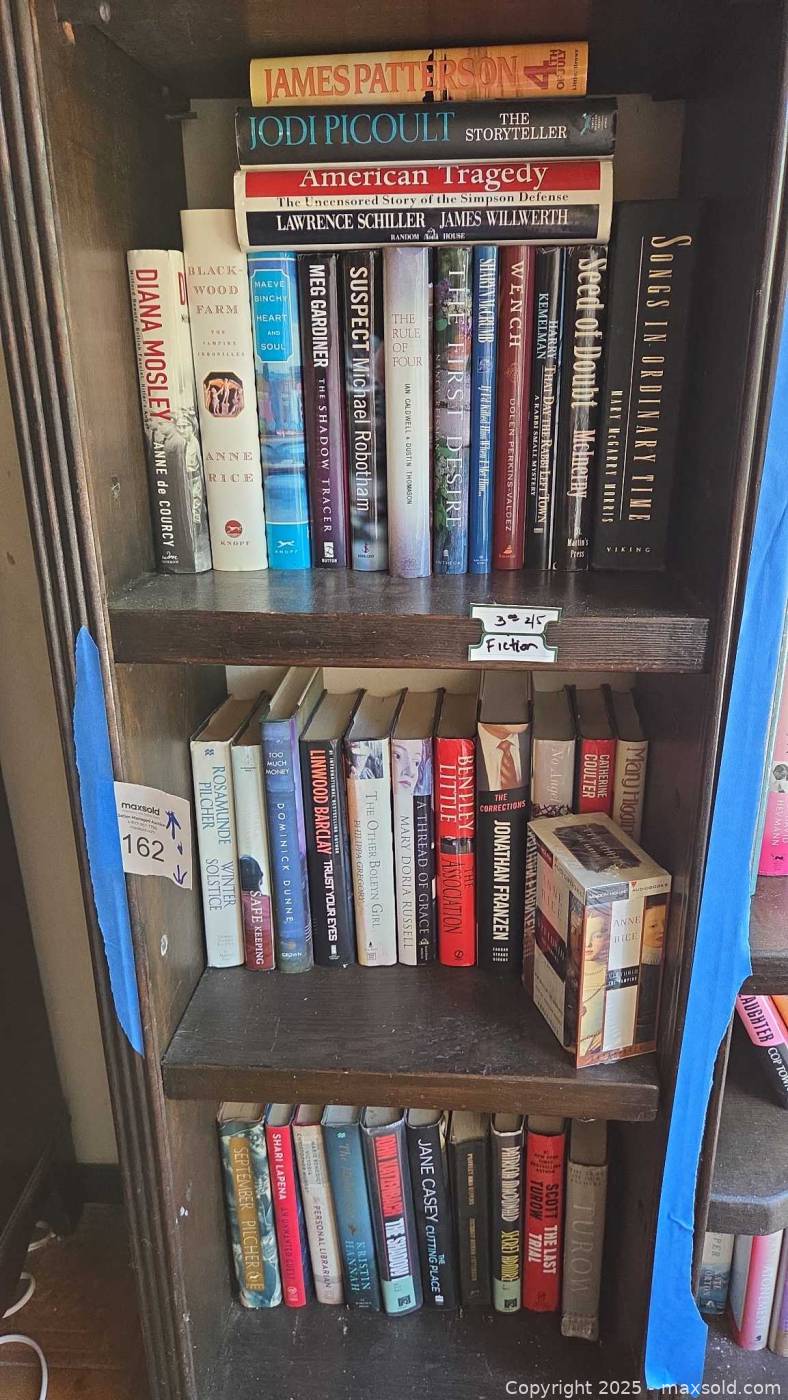 Three shelves of hardcover novels | Maxsold