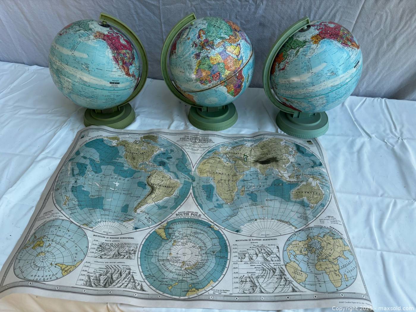 Three vintage desktop world globes, fold-out world map and “Alaska ...