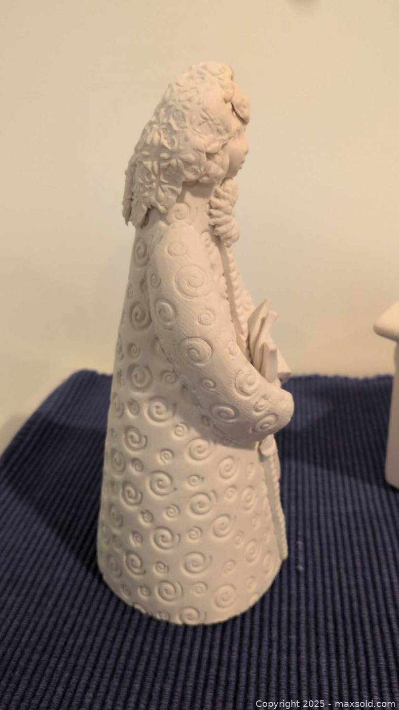 Three unpainted bisque figurines | Maxsold