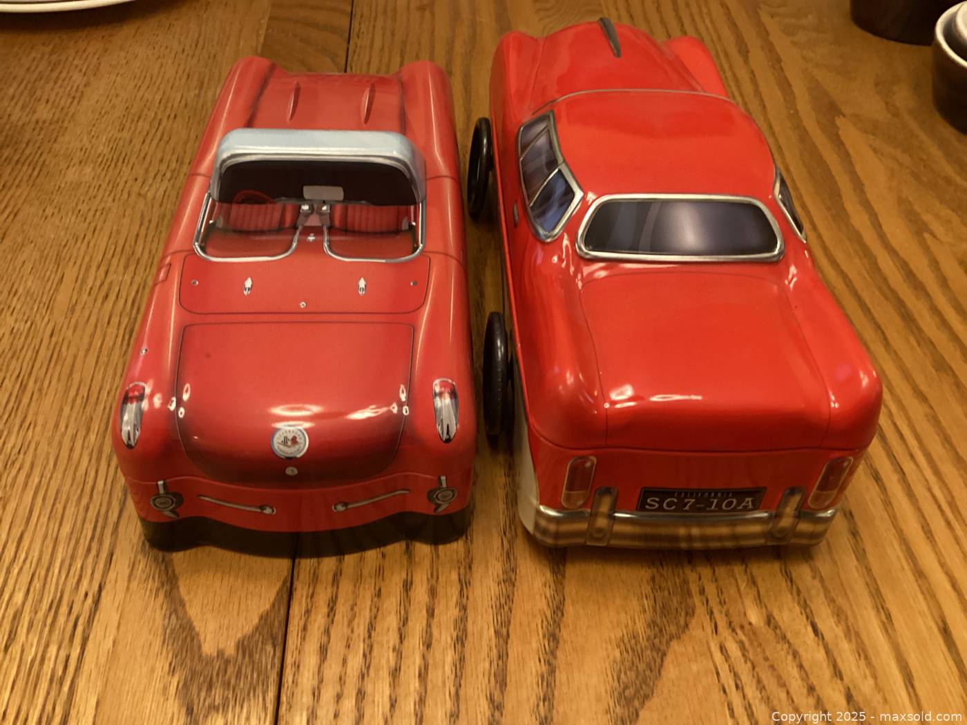 Red car-shaped metal tins | Maxsold
