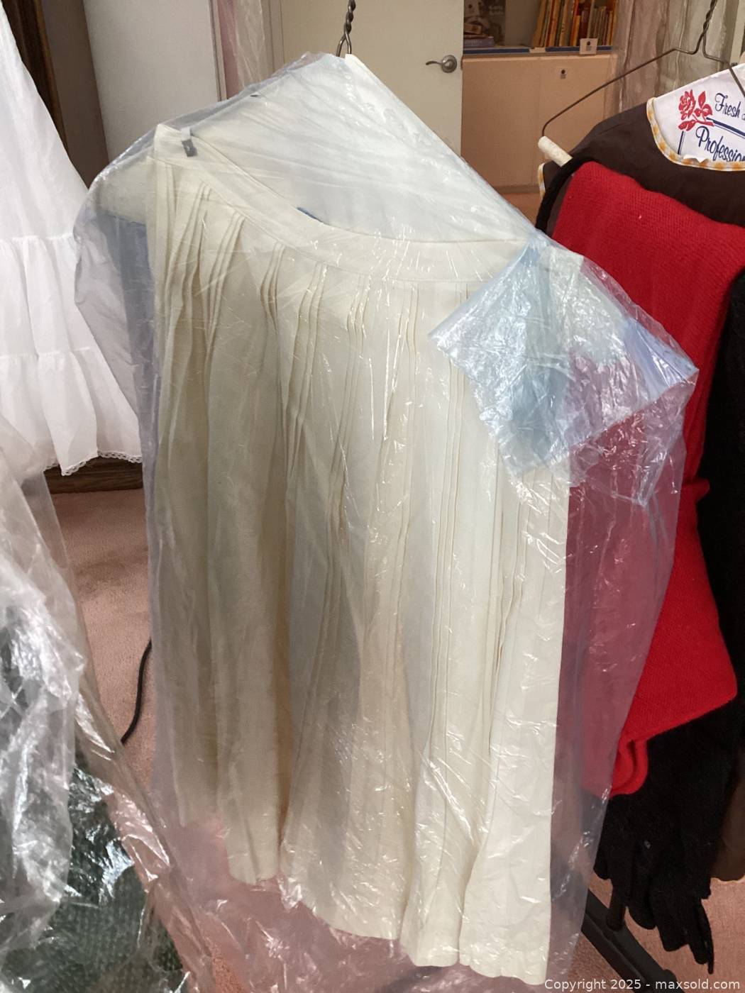 Assorted women’s vintage garments on rack | Maxsold