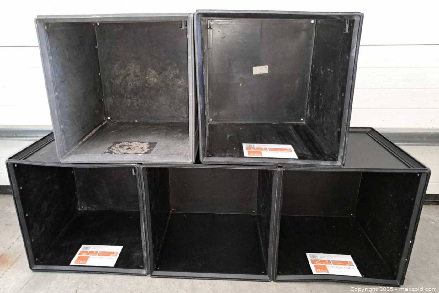 Five black plastic interlocking storage cubes with eight pins | Maxsold