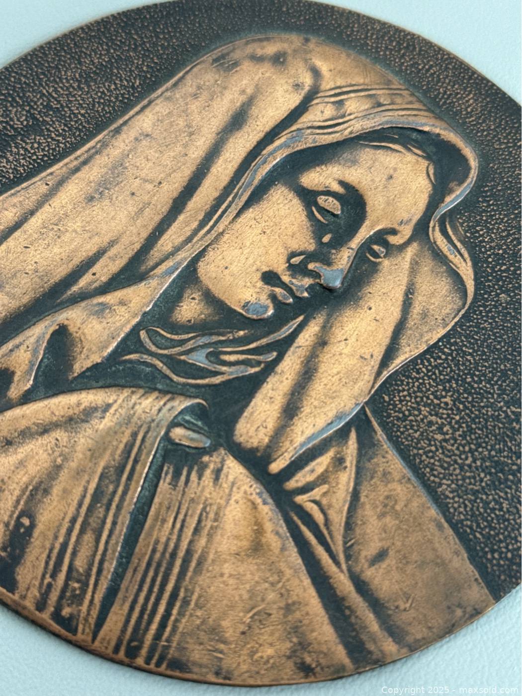 Vintage round metal crying Madonna wall plaque | Maxsold