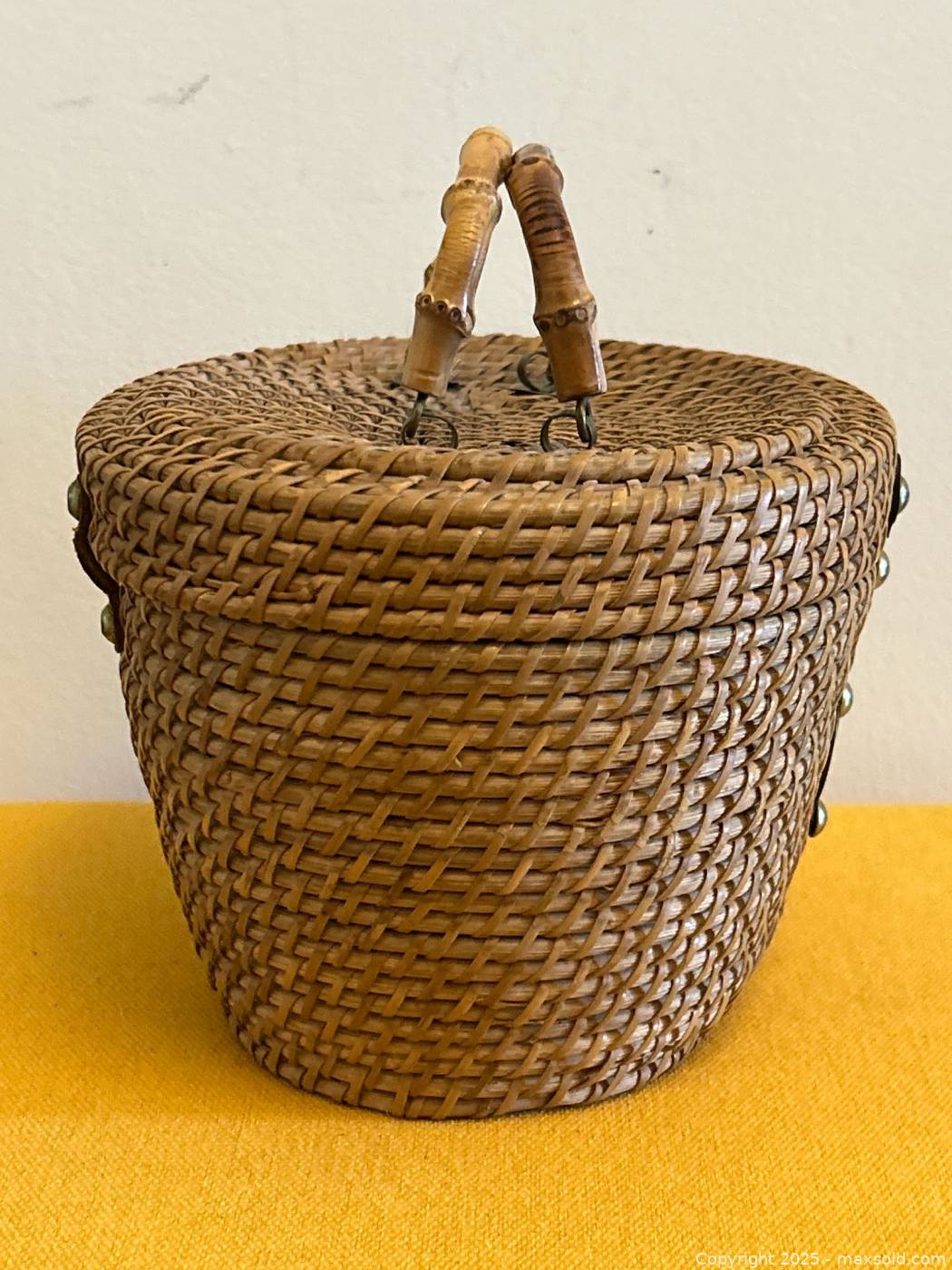 Woven rattan basket purse with brass fish clasp | Maxsold