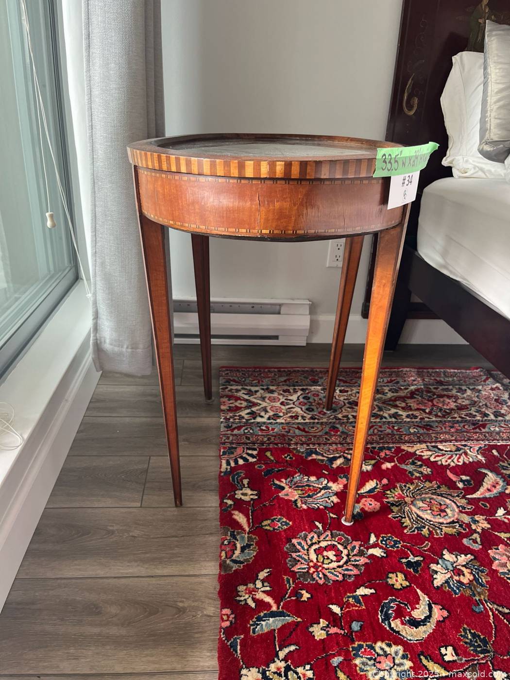 Oval glass-top inlaid display table | Maxsold
