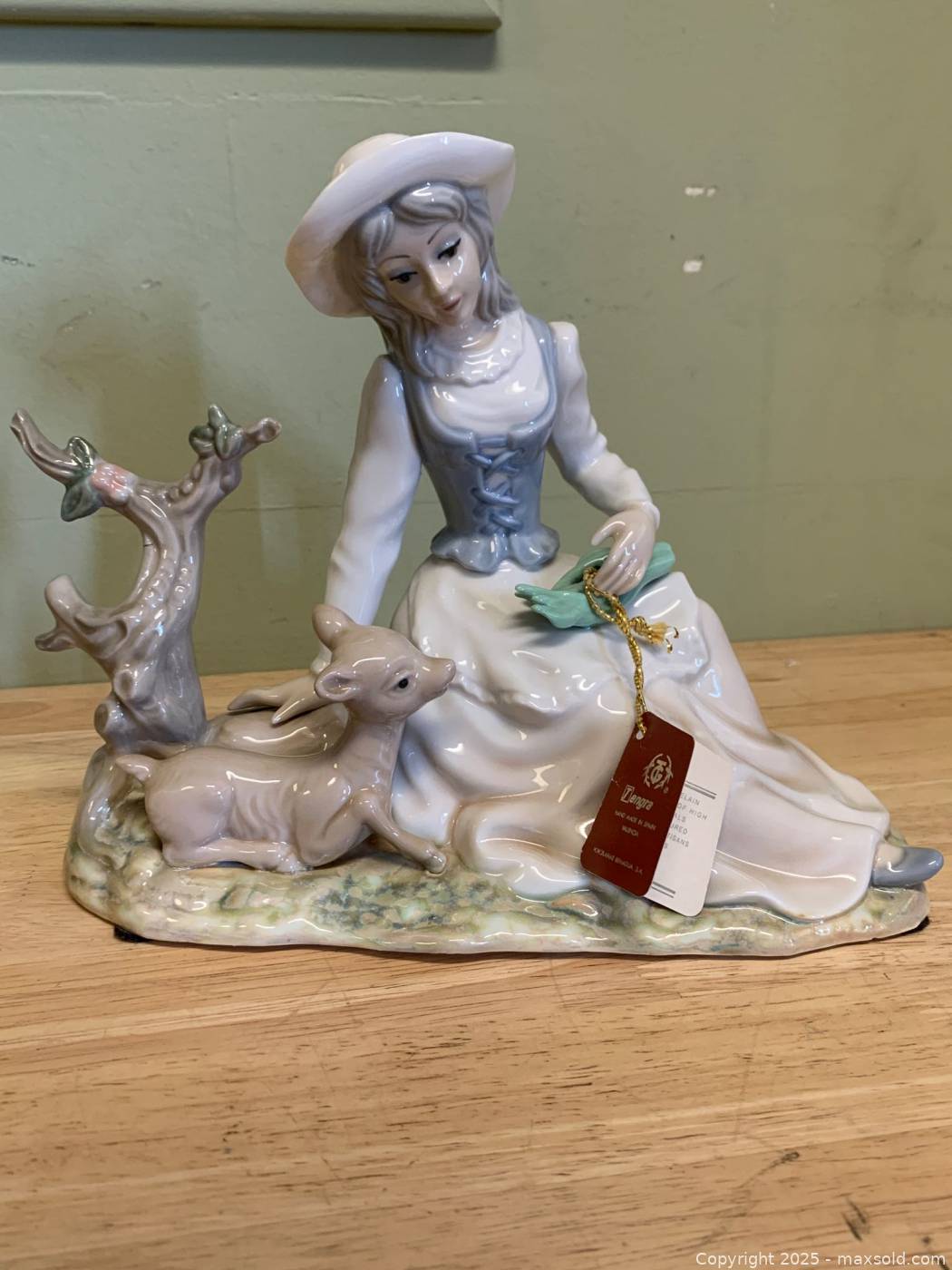 Tengra glazed porcelain seated woman with fawn figurine | Maxsold