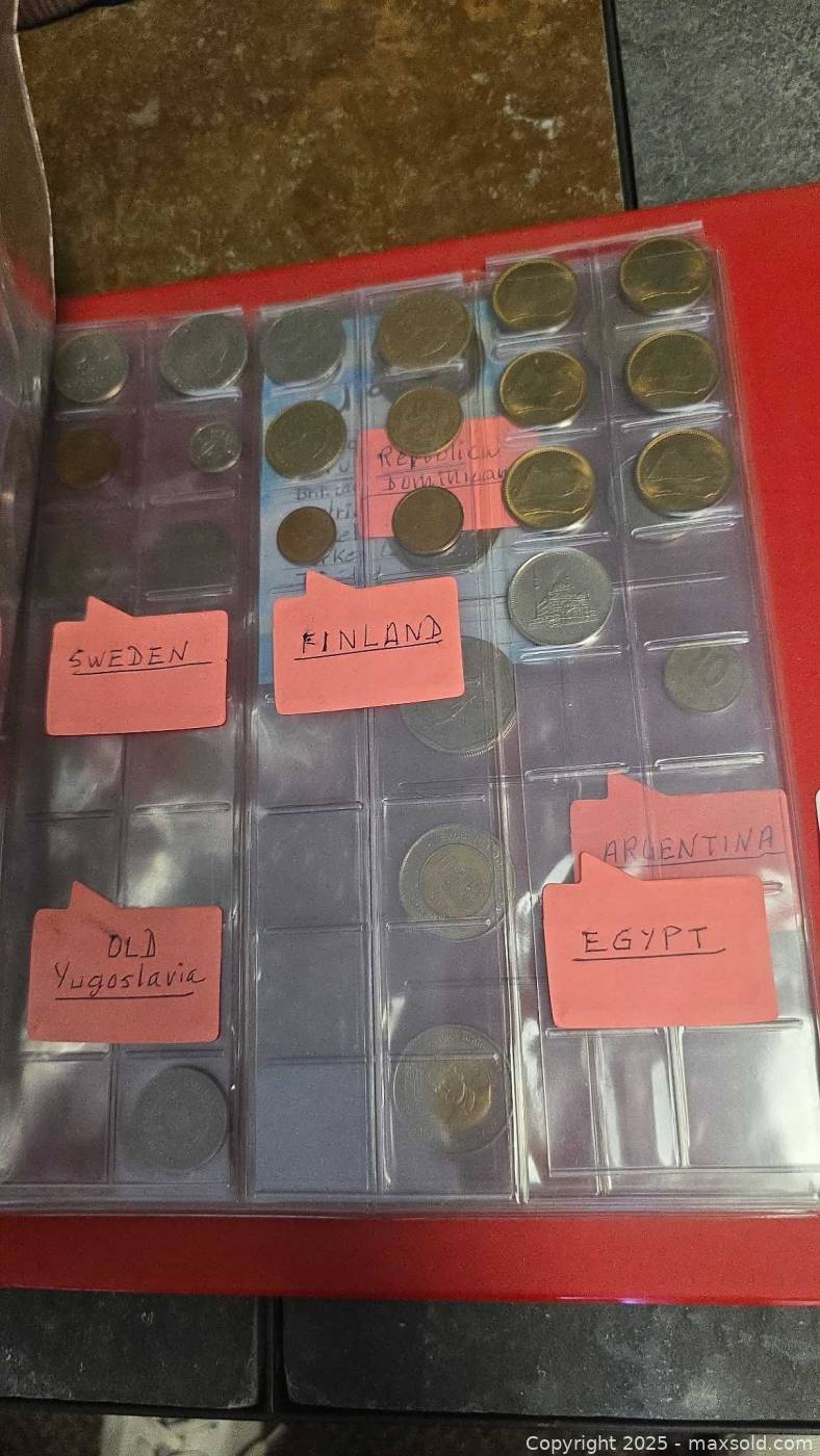 World coin collection in red binder | Maxsold