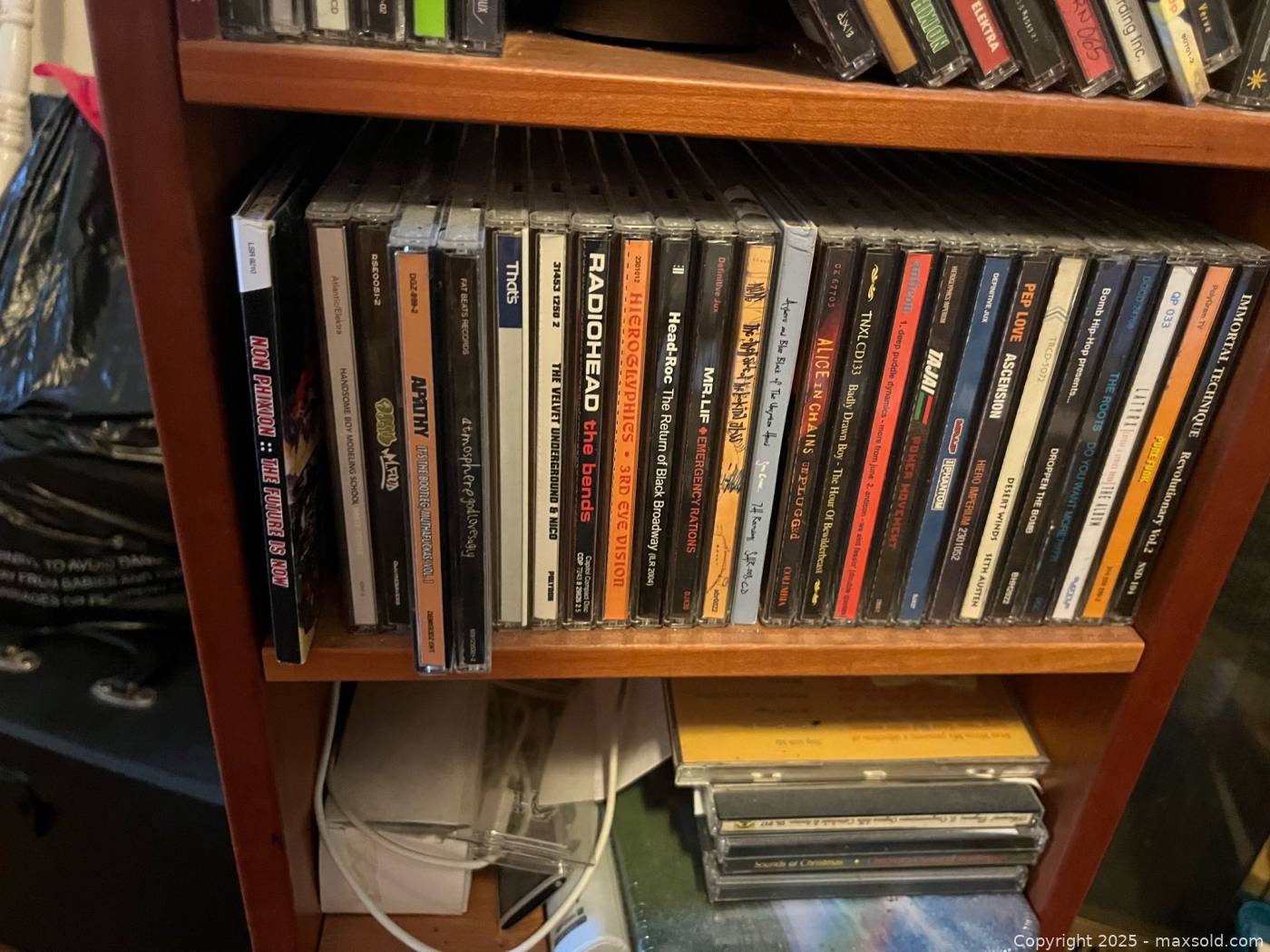 Rotating wooden CD tower with ~150 CDs | Maxsold