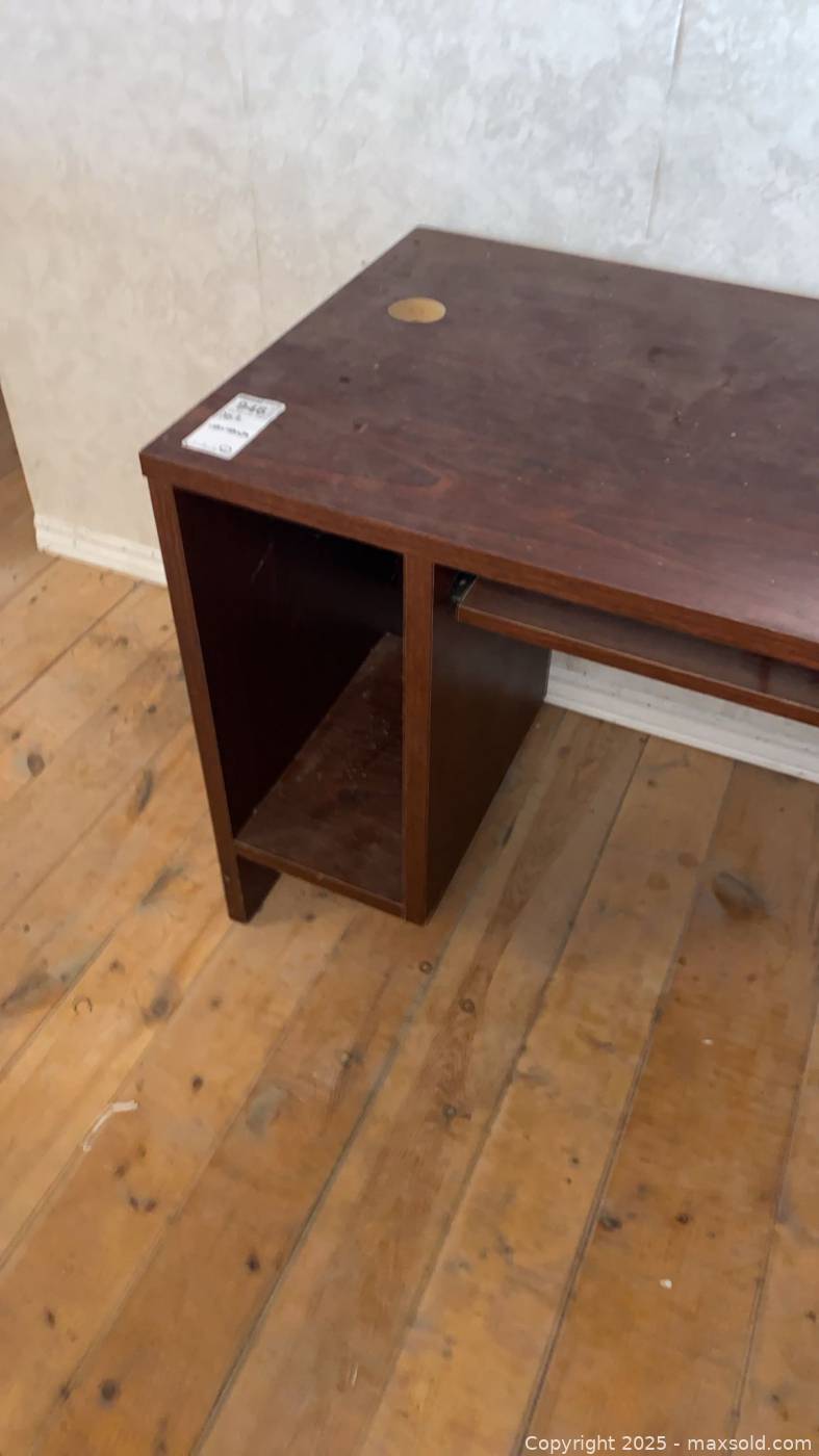 Dark brown woodgrain office desk with drawers | Maxsold