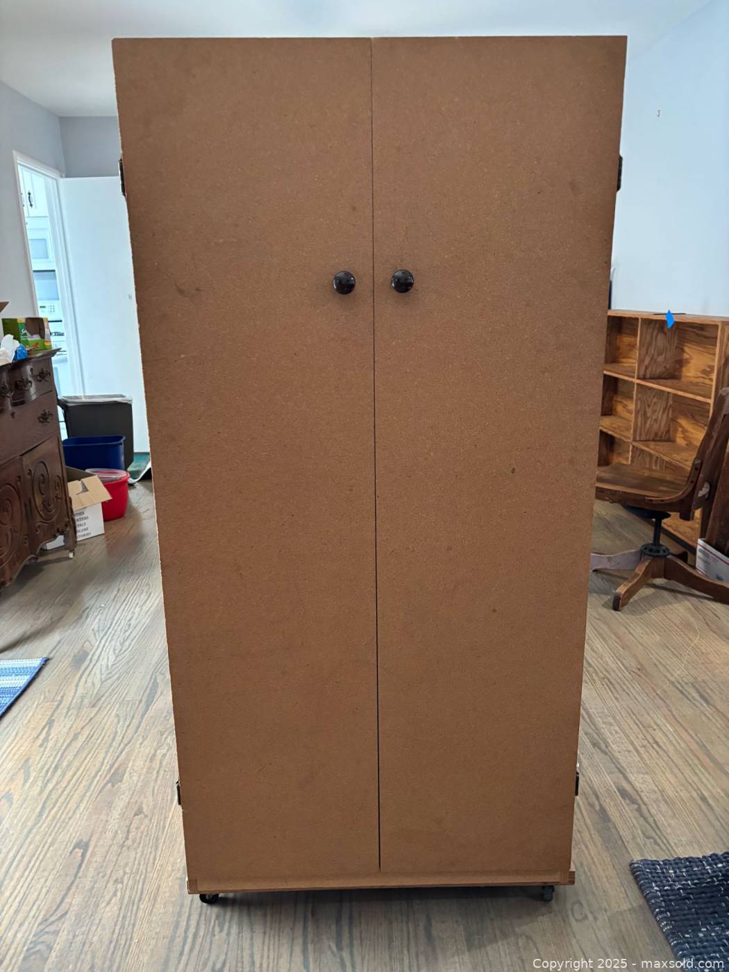 Particle board storage cabinet on casters | Maxsold