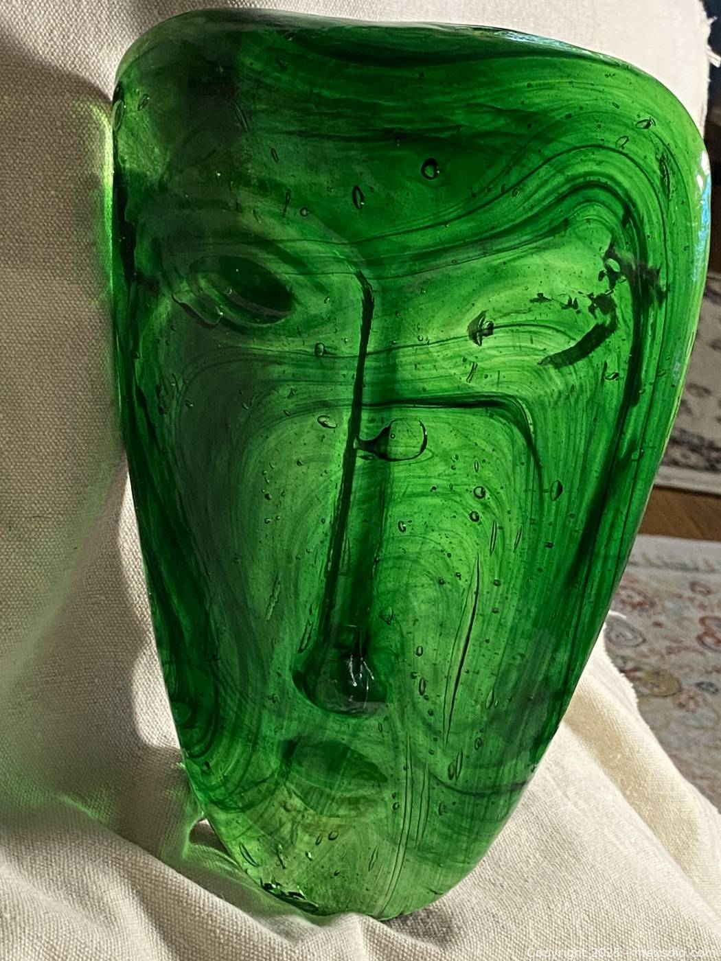 Emerald green solid art glass face mask sculpture | Maxsold