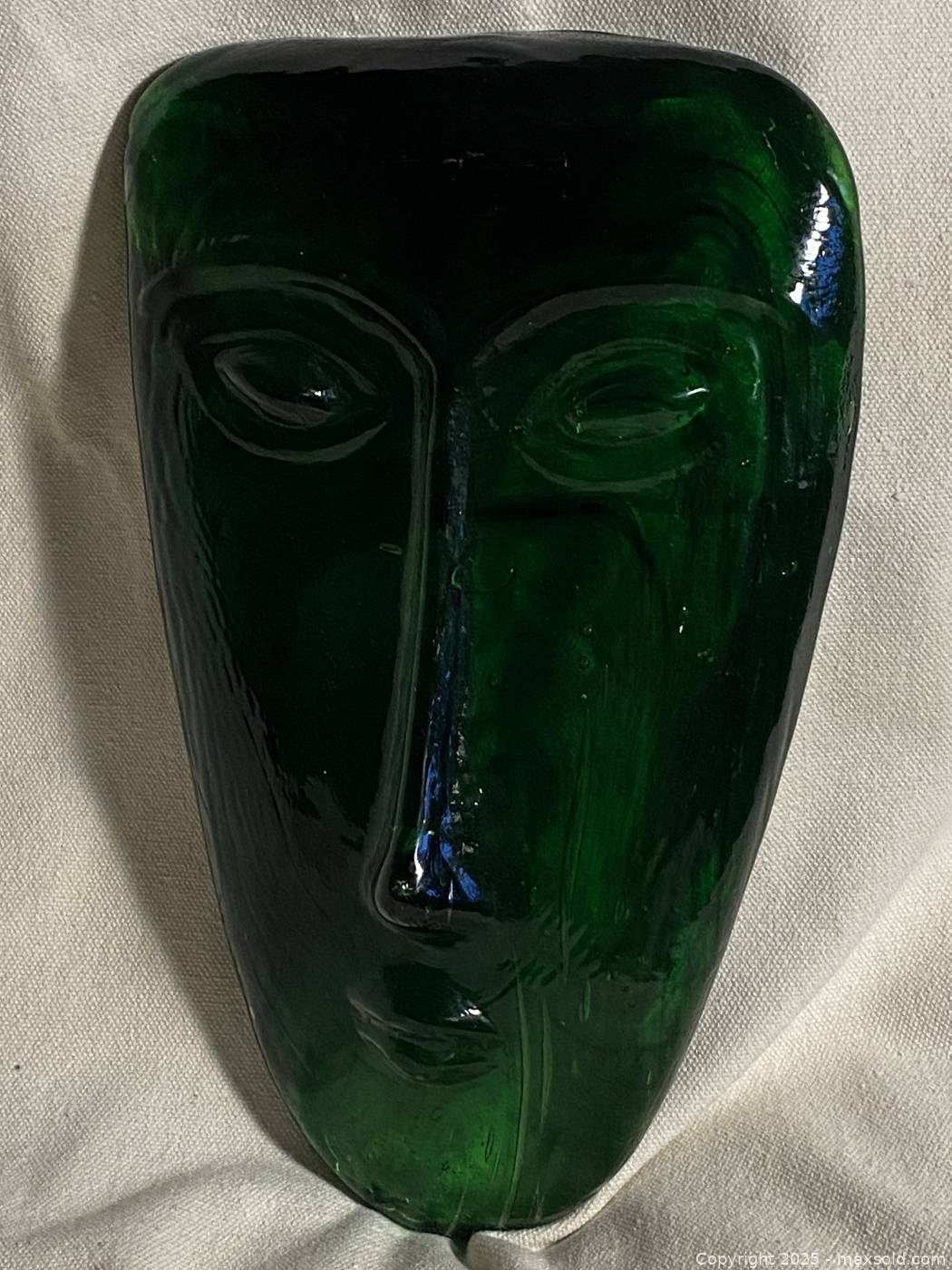 Emerald green solid art glass face mask sculpture | Maxsold