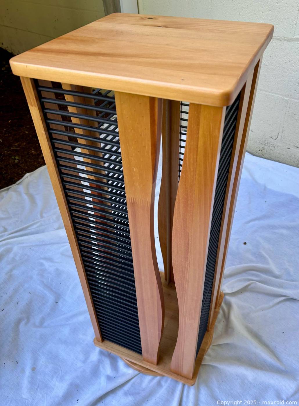 Wood revolving CD tower with two plastic racks | Maxsold