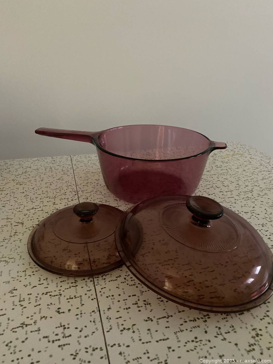 Visions cranberry glass saucepan with 2 lids | Maxsold