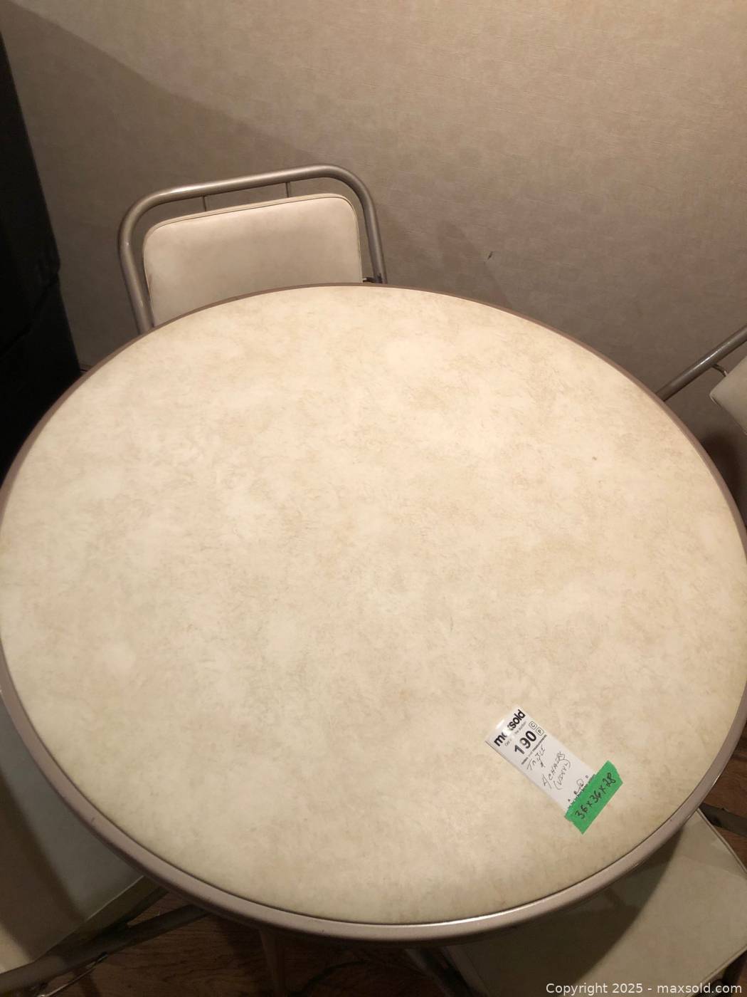 Round card table and 4 vinyl folding chairs | Maxsold