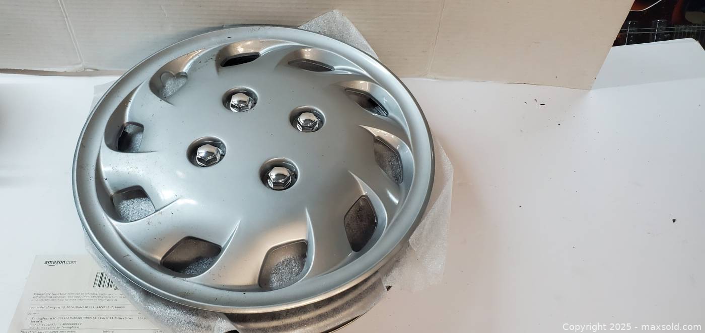 Three silver 14-inch plastic hubcaps | Maxsold