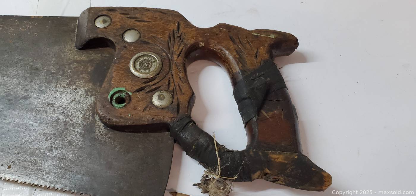 Vintage wooden-handle hand saw with taped grip | Maxsold