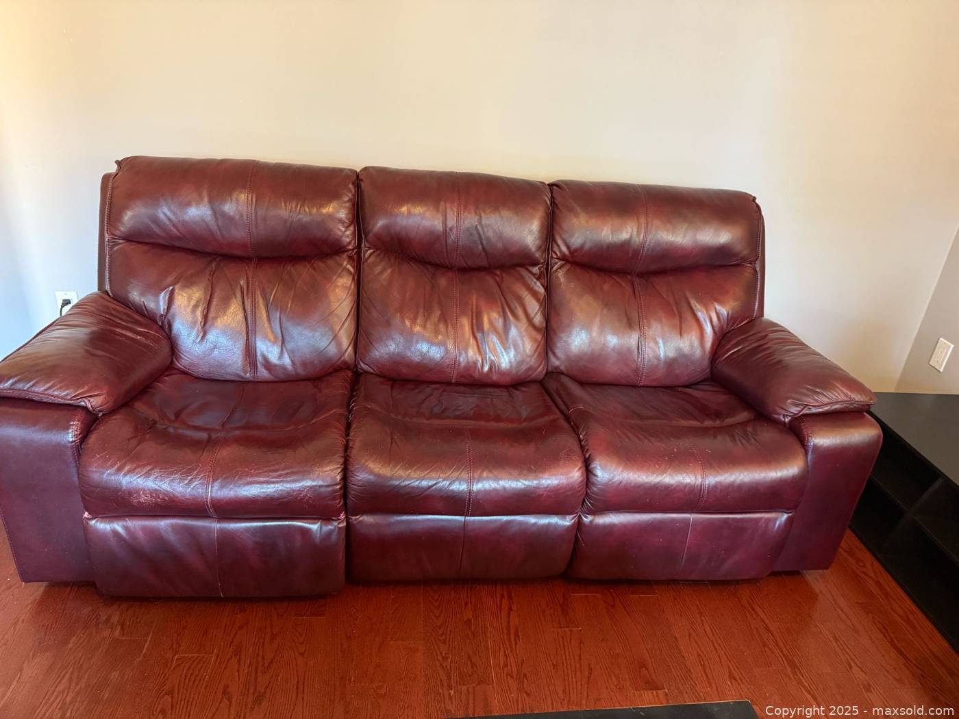 Cranberry leather three-seat reclining couch | Maxsold