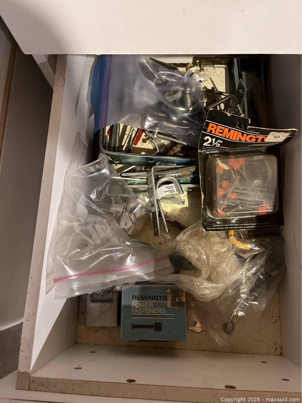 Four-drawer cabinet with granite top and assorted small hardware | Maxsold