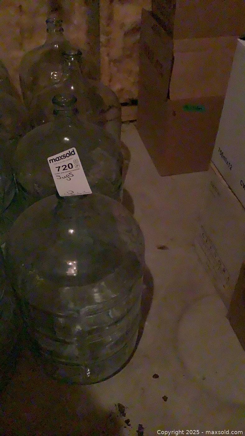 Four clear glass carboys | Maxsold