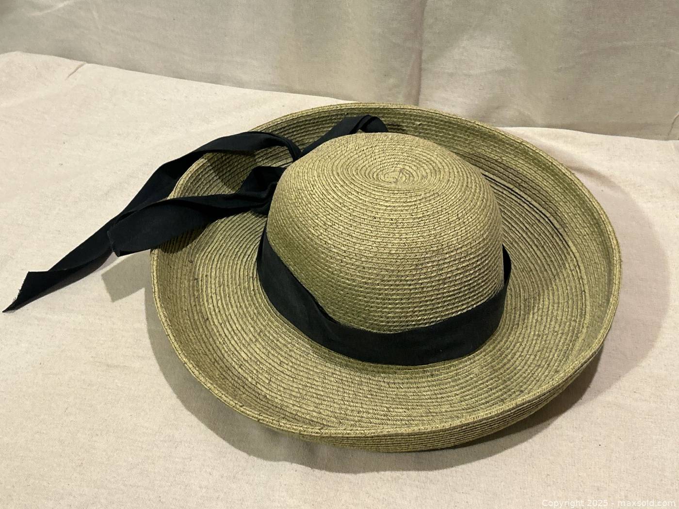 Green straw hat with black ribbon | Maxsold