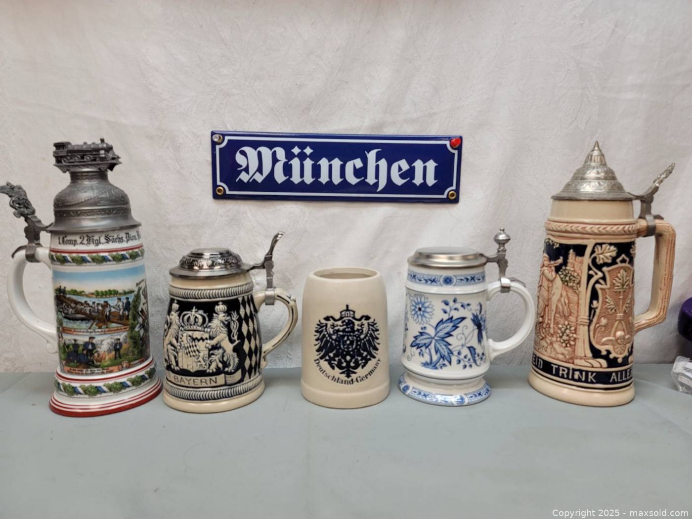 Five German beer steins and München sign | Maxsold