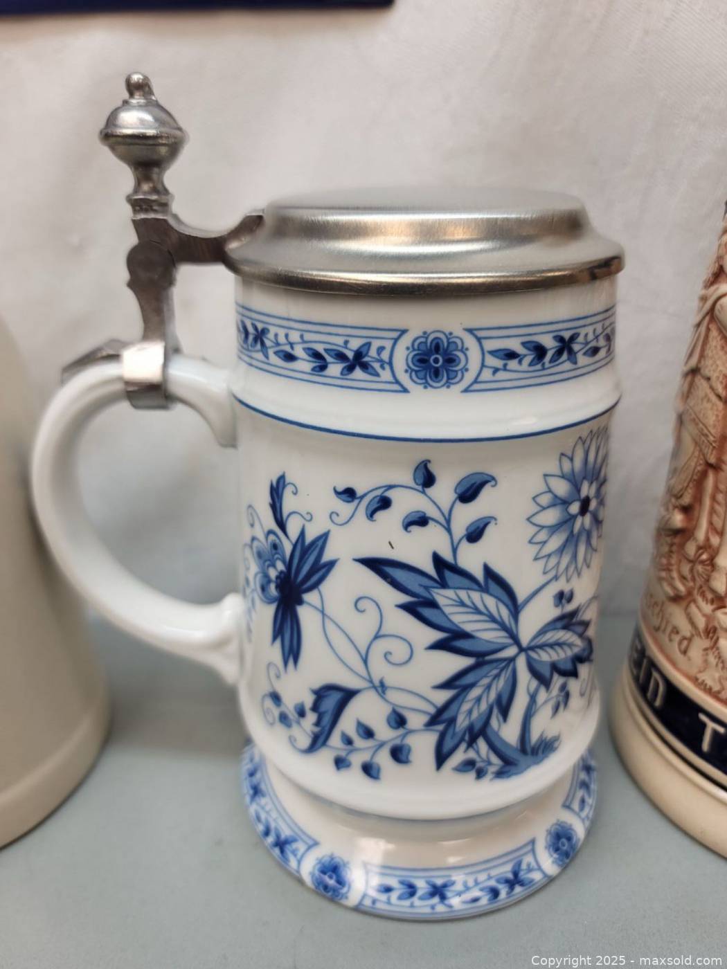 Five German beer steins and München sign | Maxsold