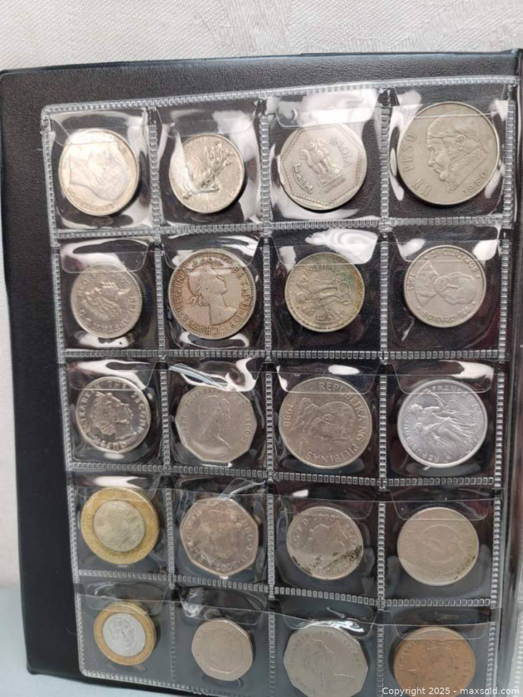Coin album with assorted world coins | Maxsold