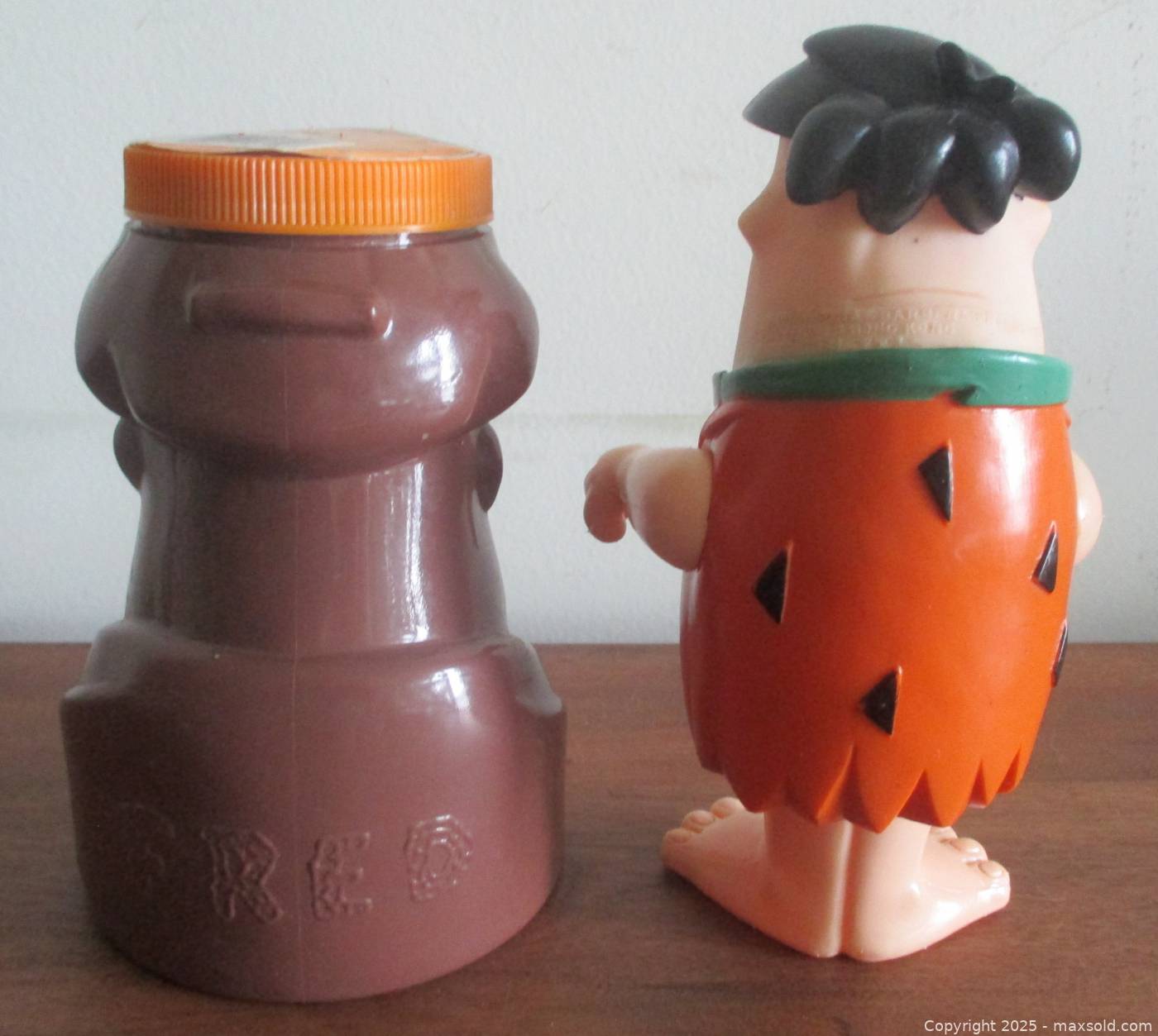 Fred Flintstone 1998 vinyl figure and 1993 Grenache plastic jar | Maxsold