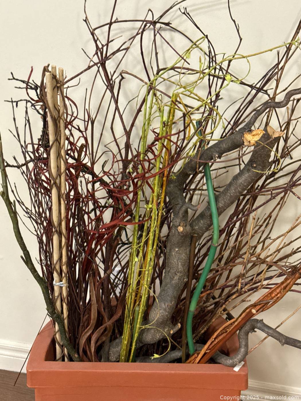 Resin planter with decorative twig arrangement | Maxsold